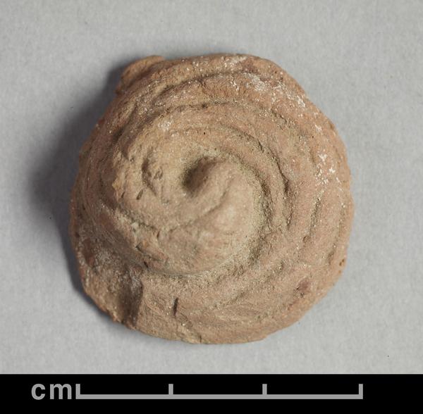 Collection object "MAS.325" • Fragment of figure made of reddish brown ...