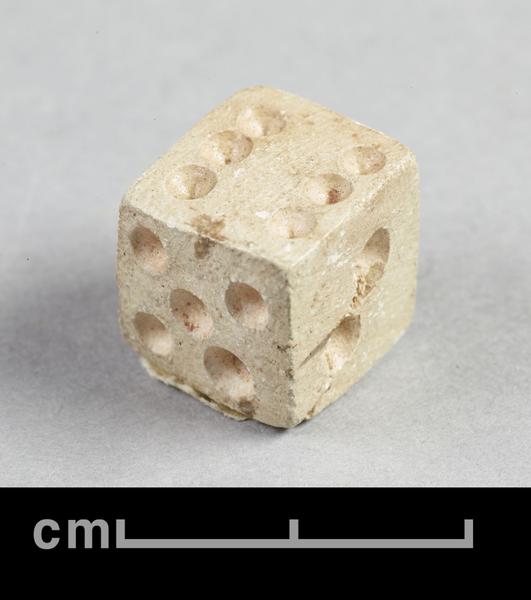 Collection object "MAS.602" • Small bone die with incised round pips ...